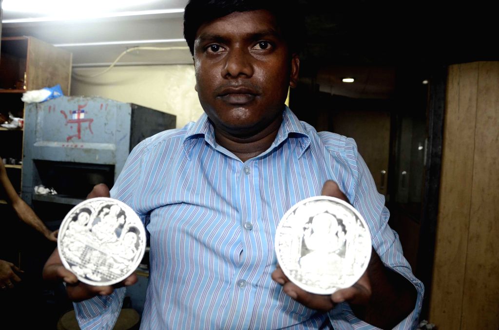 Silversmith mints silver coins at Zaveri Bazar workshop
