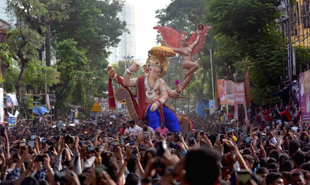 :Mumbai:Devotees join a procession with an idol of lord Ganesha.