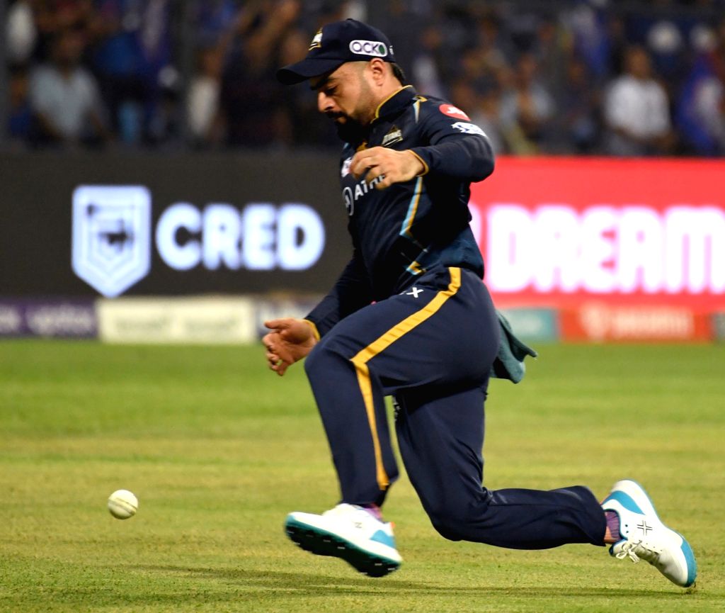 Mumbai : GT's Rashid Khan fields to save a boundary during the IPL 2023 ...