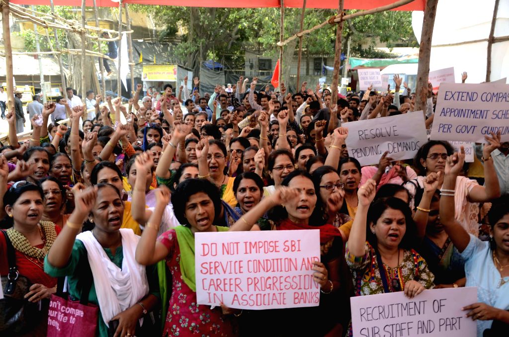 Employees of associate banks of SBI demonstrate in Mumbai