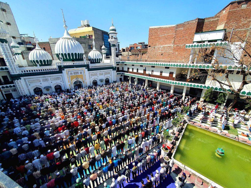 Muslim devotees offer prayers on the first Friday of the holy month of ...