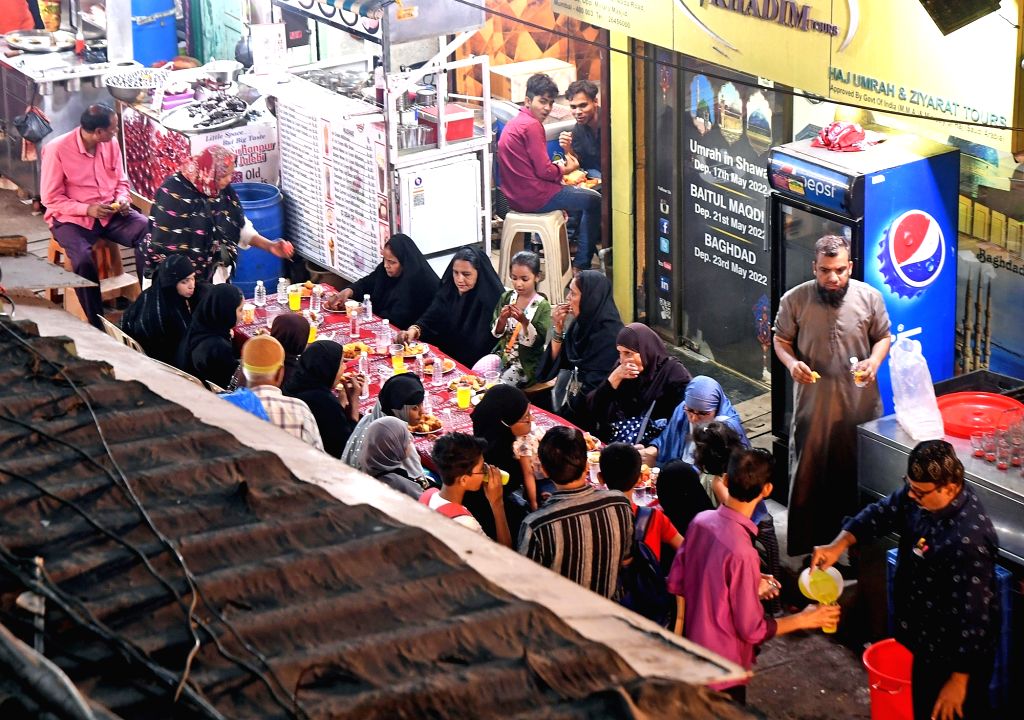 Muslim people break their fast during Iftar