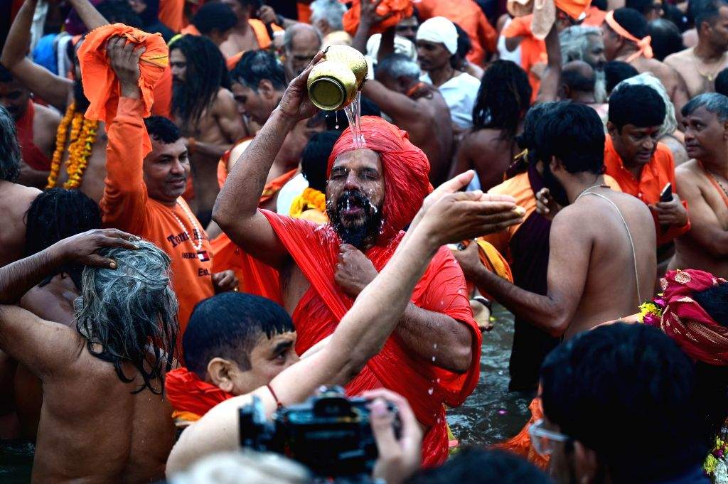 Naga Sadhus (Holy Men) take a holy dip at the Triveni Sangam