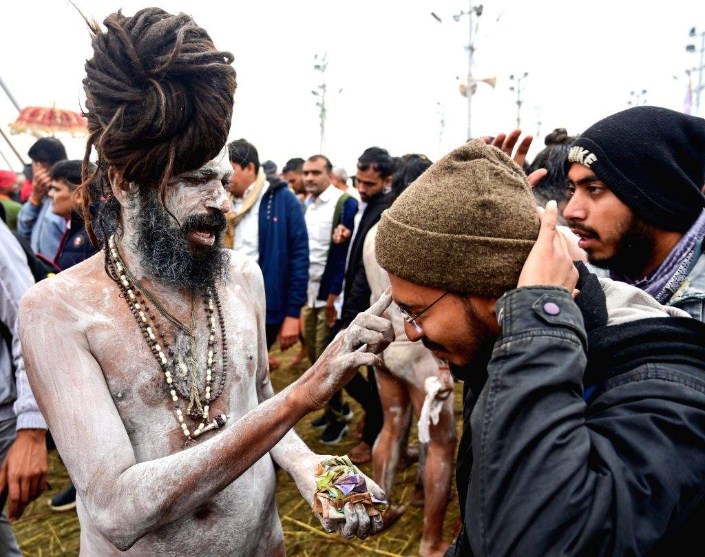 Naga Sadhus (Holy Men) take a holy dip at the Triveni Sangam