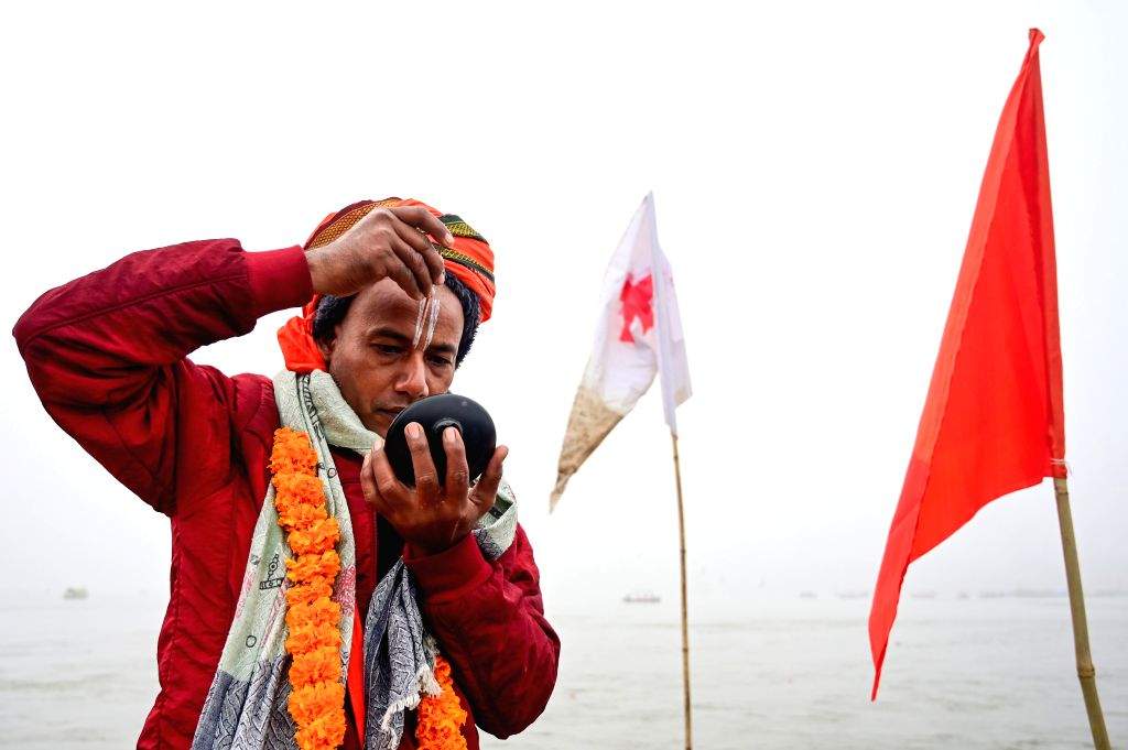 Naga Sadhus (Holy Men) take a holy dip at the Triveni Sangam