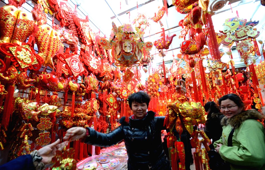 A consumer selects New Year decorations at a shopping mall in Nanchang