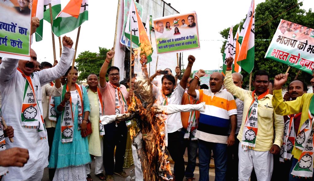 Nationalist Congress Party workers burn an effigy of PM Narendra Modi.