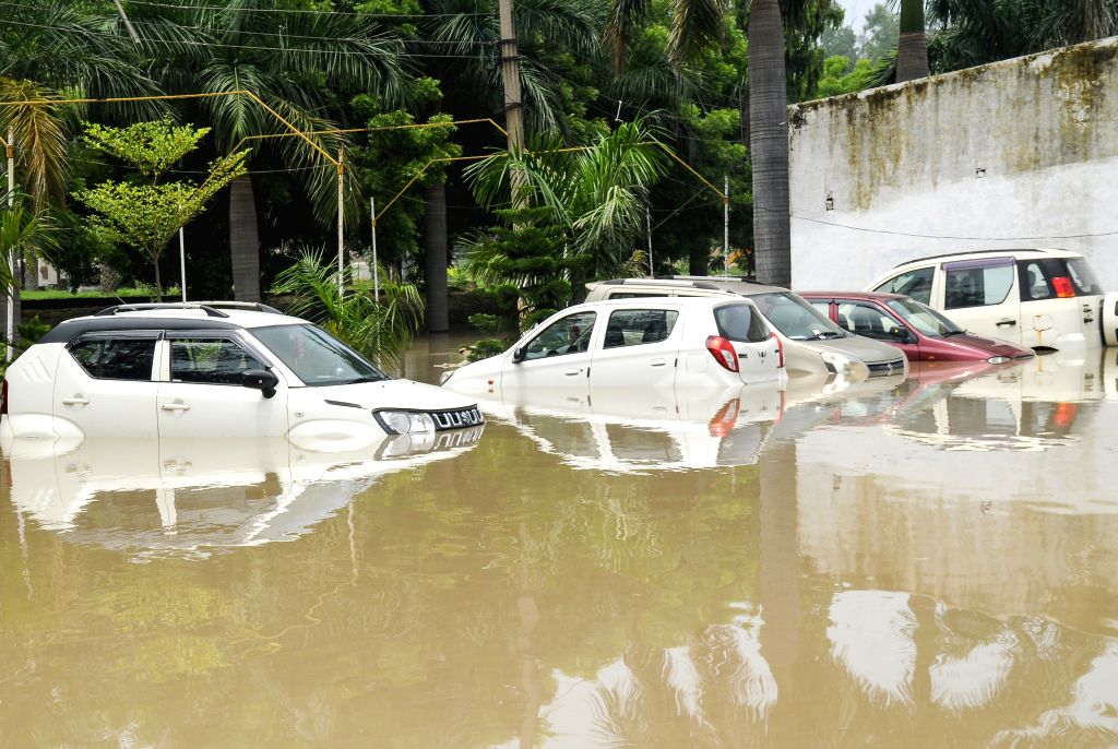 New Delhi : A man stands in floodwater in front of Namaskar Gurudwara