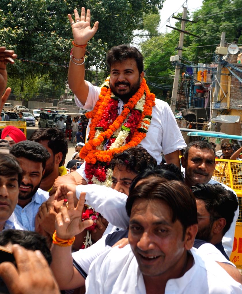 New Delhi : AAP candidate Durgesh Pathak waves to his supporters during ...
