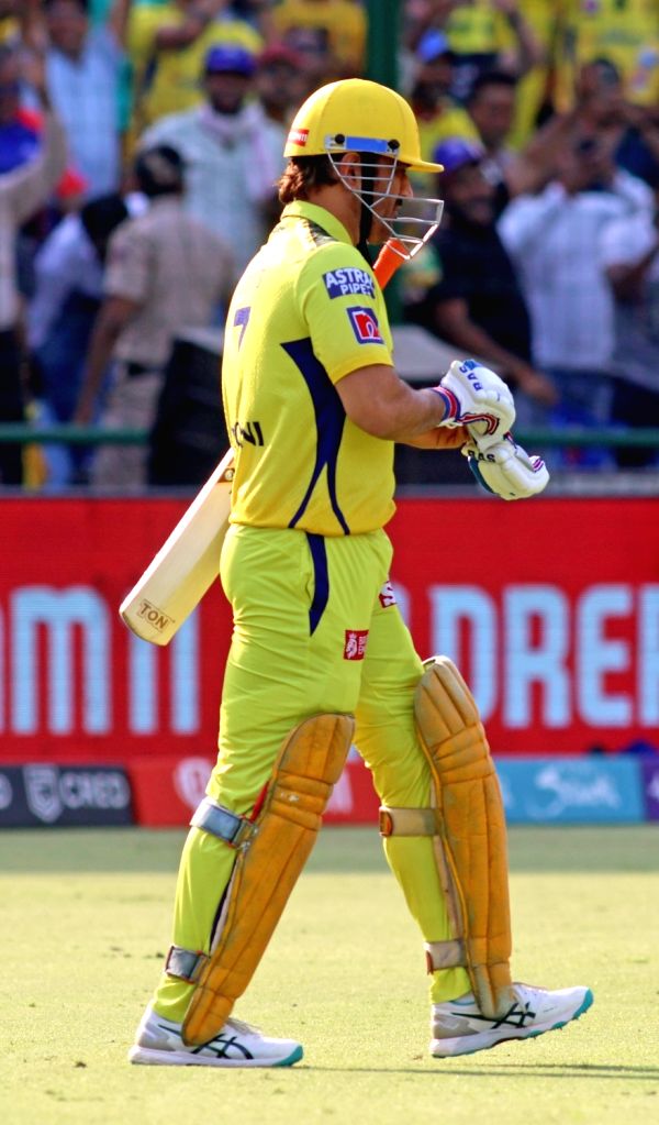 : New Delhi : CSK's captain MS Dhoni walks in the field to bat during ...