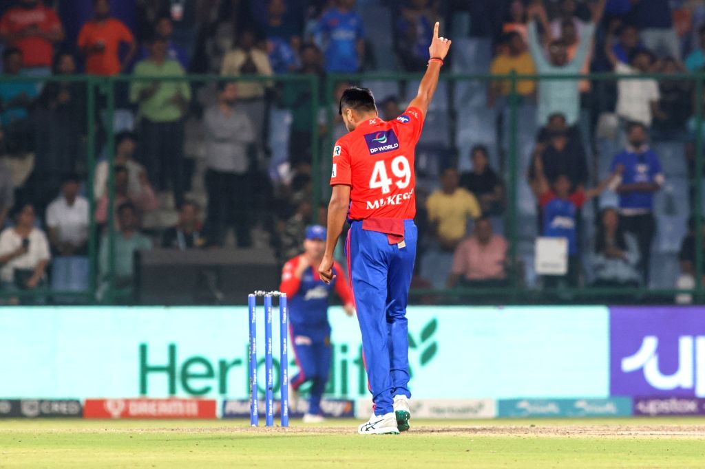 DC bowler Mukesh Sharma celebrates the dismissal of MI's Tilak Varma
