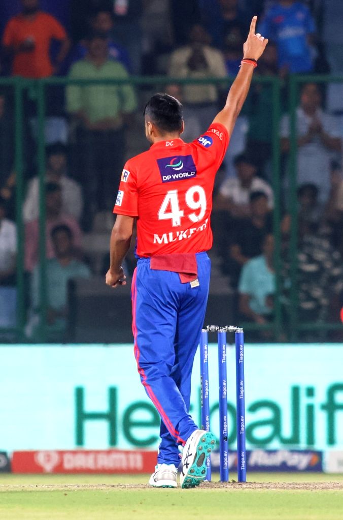 DC bowler Mukesh Sharma celebrates the dismissal of MI's Tilak Varma