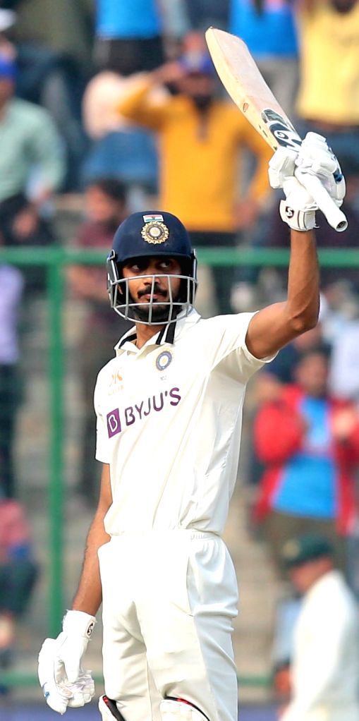 : New Delhi : India's Axar Patel raises his bat to celebrate scoring a ...