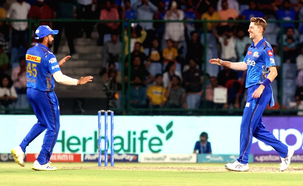 MI bowler Riley Meredith with team captain Rohit Sharma celebrate the ...
