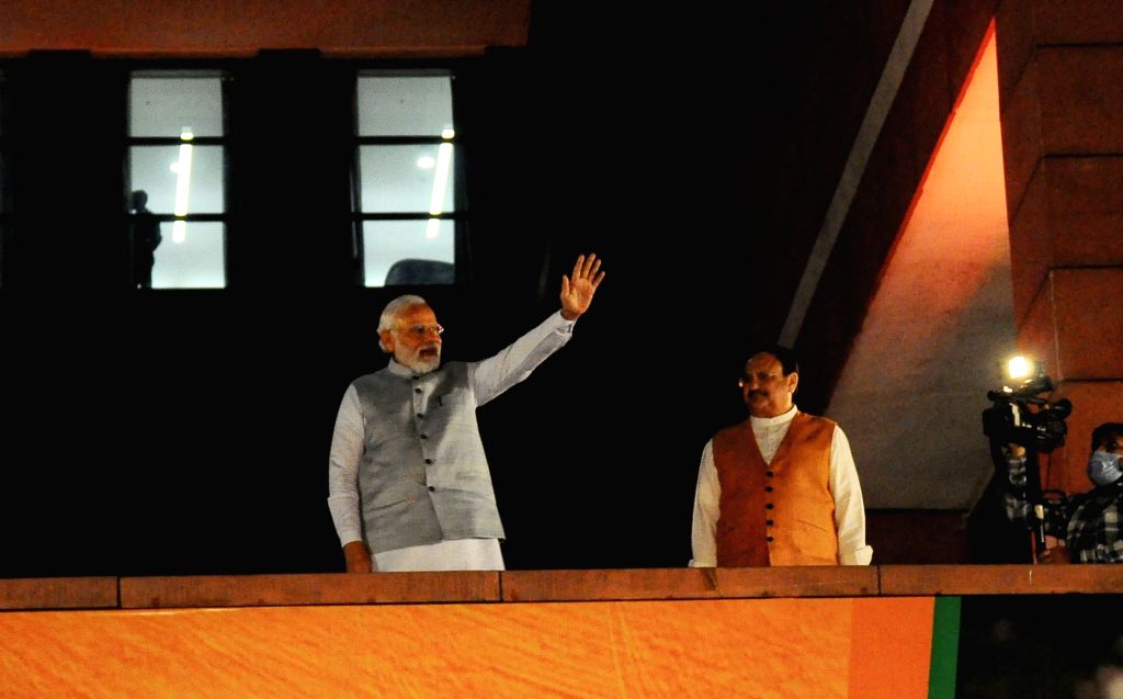 New Delhi:Prime Minister Narendra Modi waves to supporters at party ...