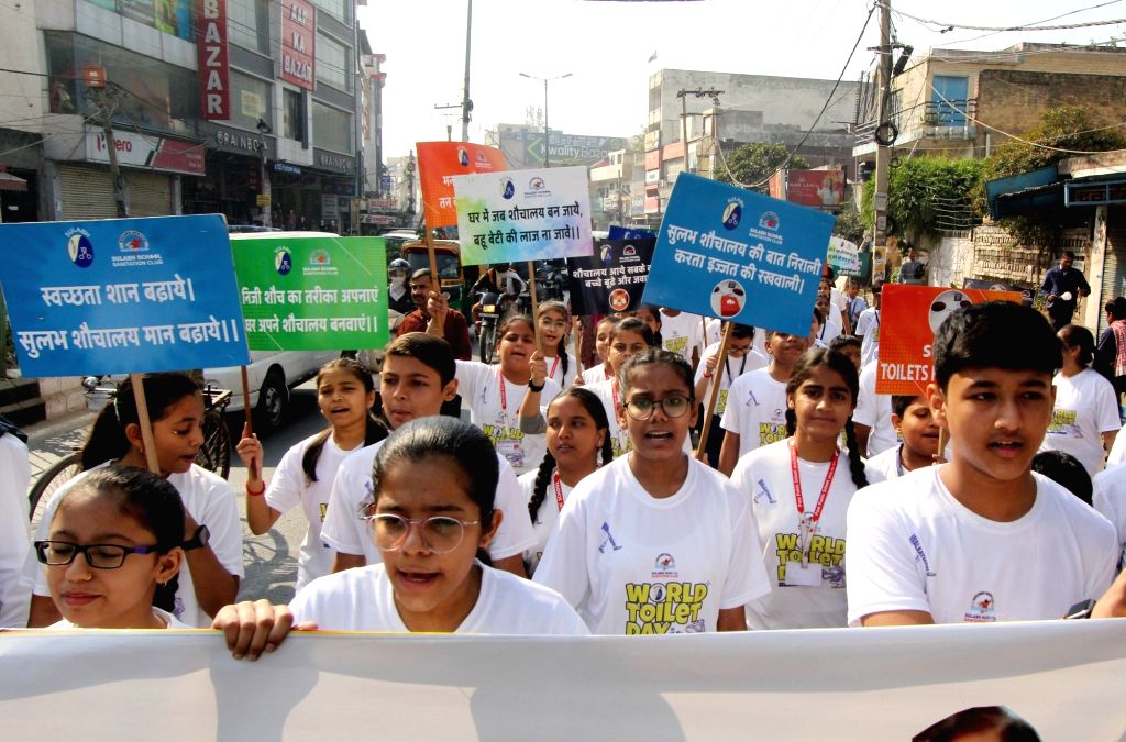 :New Delhi:School childrens hold placards as they take part in an ...