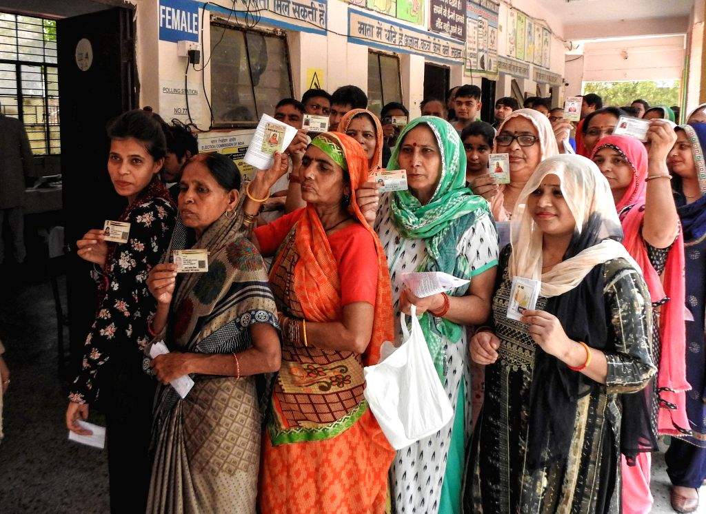 New Delhi : Voters stand in a queue to cast their vote in the sixth ...