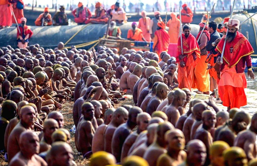 Newly initiated Naga Sadhus gather at the Sangam for a ritual bath ...