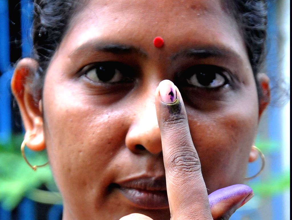 North 24 Parganas: Women show their inked fingers after casting vote at ...