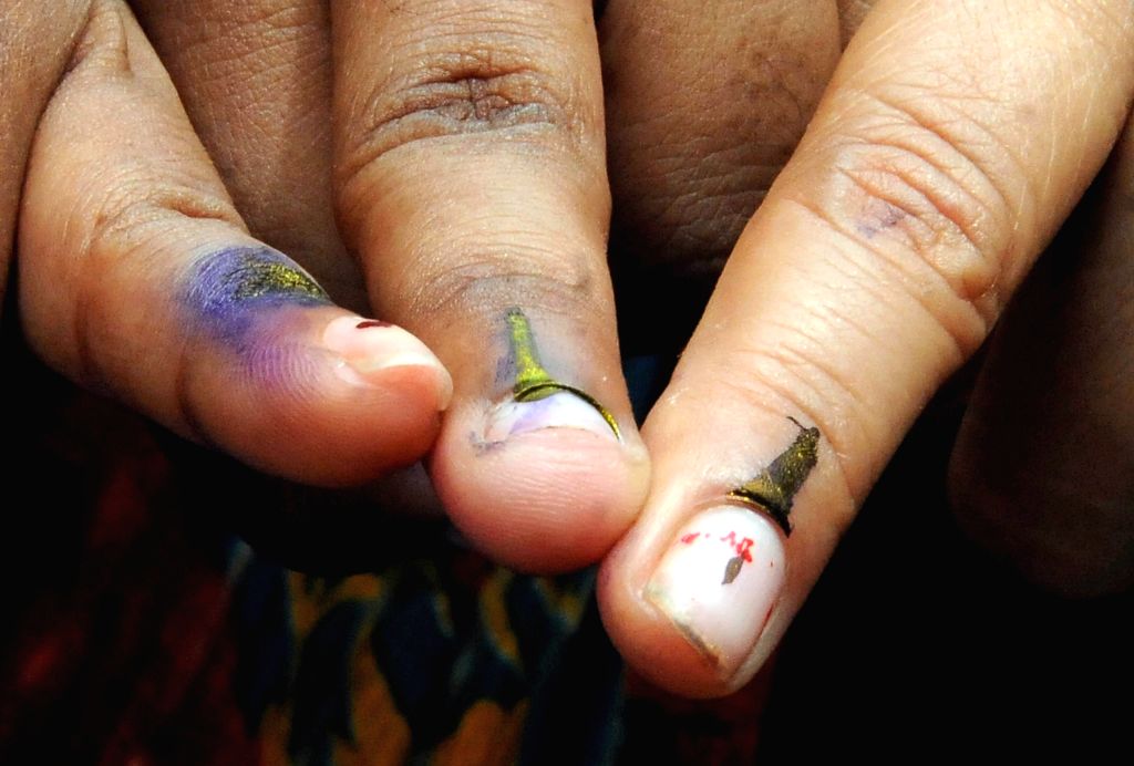 North 24 Parganas: Women show their inked fingers after casting vote at ...