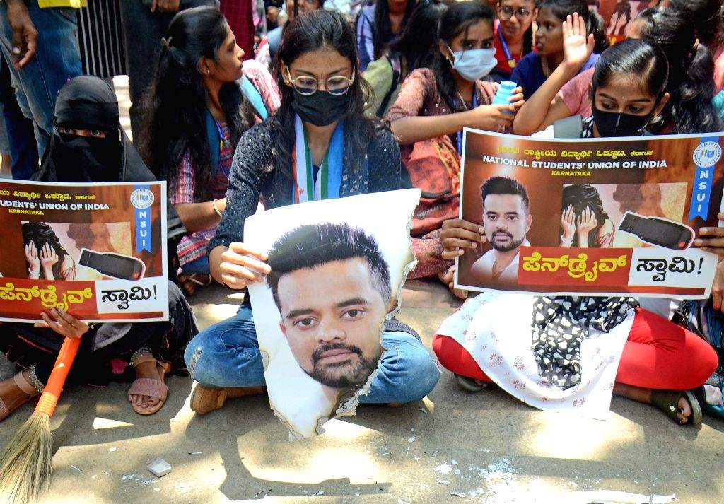 NSUI members burn a poster of JD(S) MP Prajwal Revanna during a protest ...