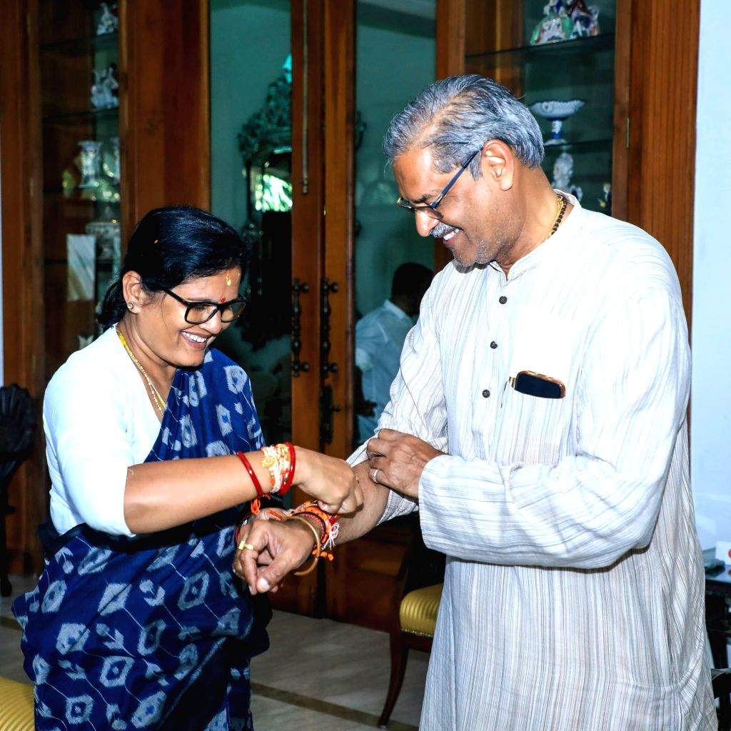 Odisha Deputy Chief Minister Pravati Parida ties a ‘rakhi’ onto the ...