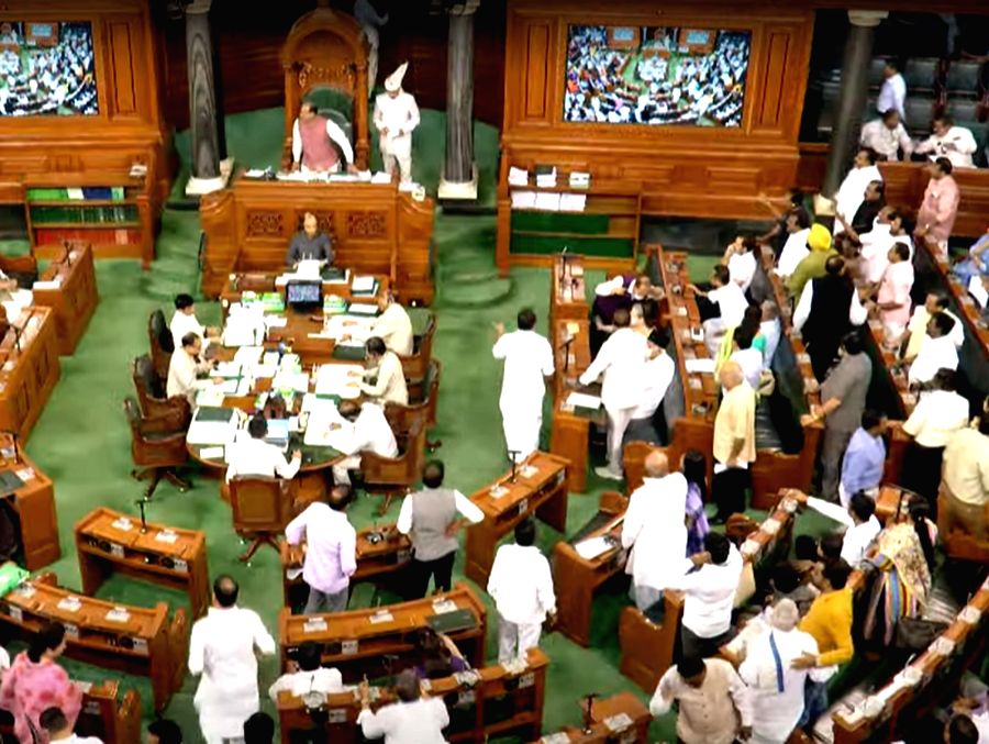 Opposition members protest in the Lok Sabha during the Budget Session ...