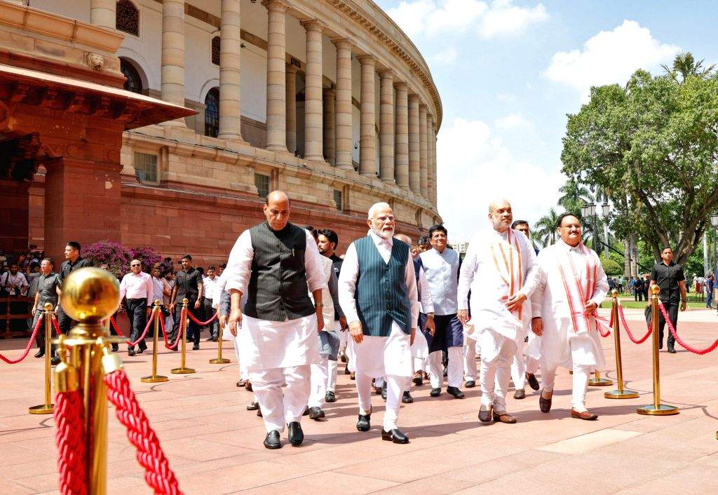 Parliamentarians walk from the old parliament to the new parliament ...