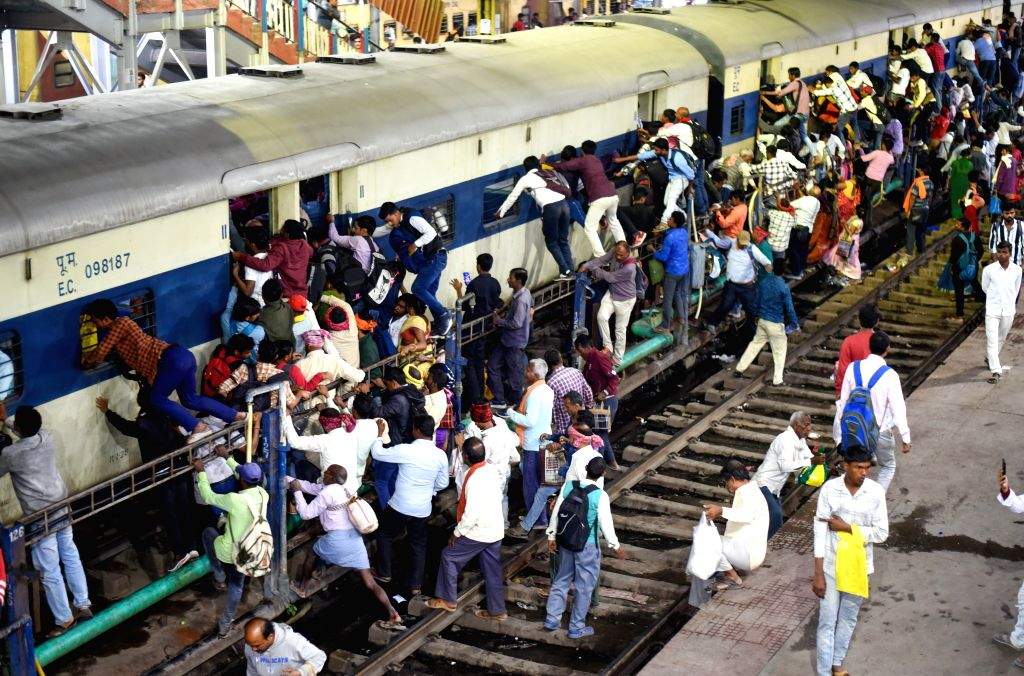 Passengers board a crowded train