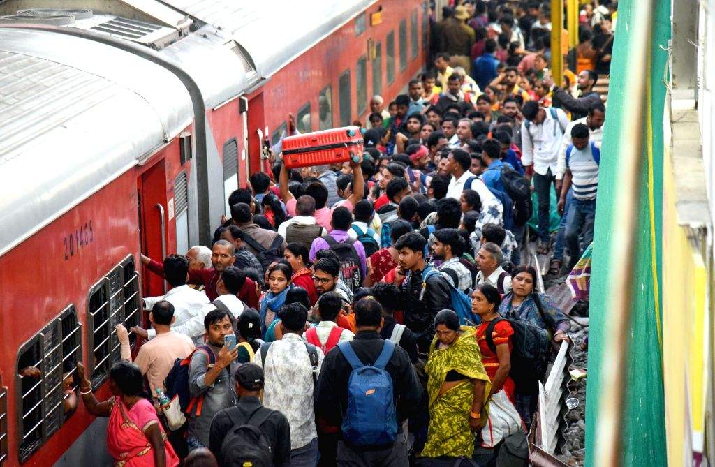 Passengers board a crowded train