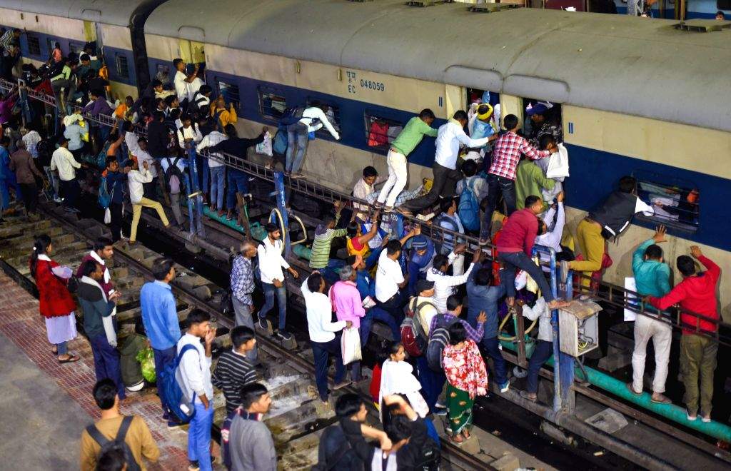 Passengers board a crowded train