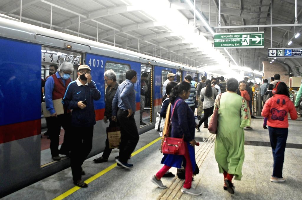 Passengers deboard a metro at Joka Taratala metro station