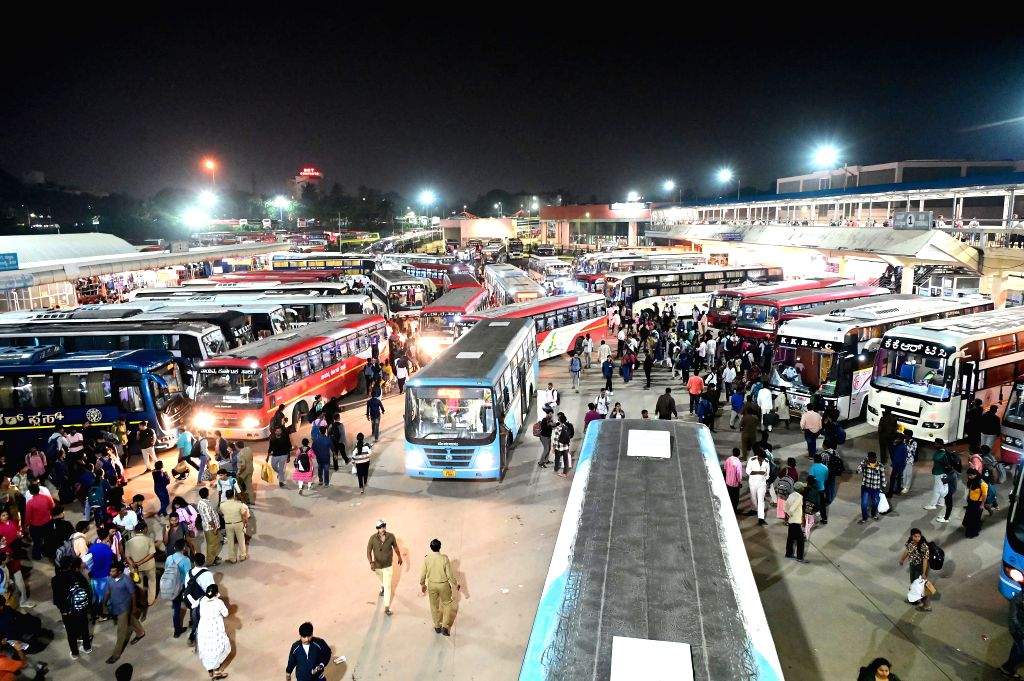 Passengers waiting to board buses at Majestic Bus Stand