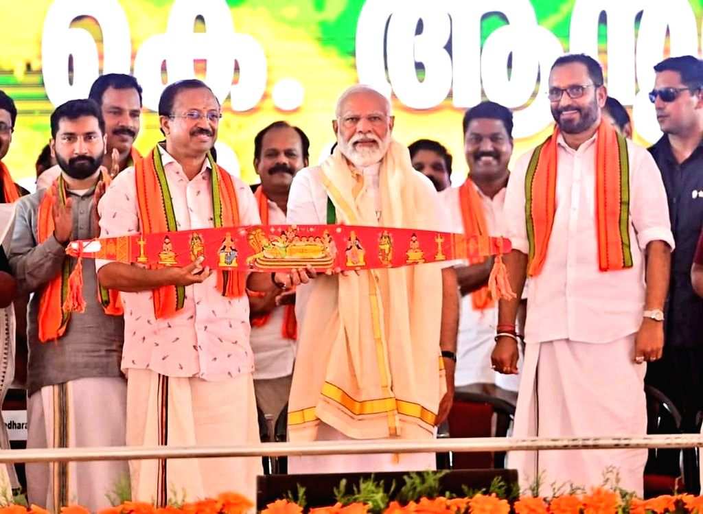 Prime Minister Narendra Modi being presented the traditional Onavillu ...