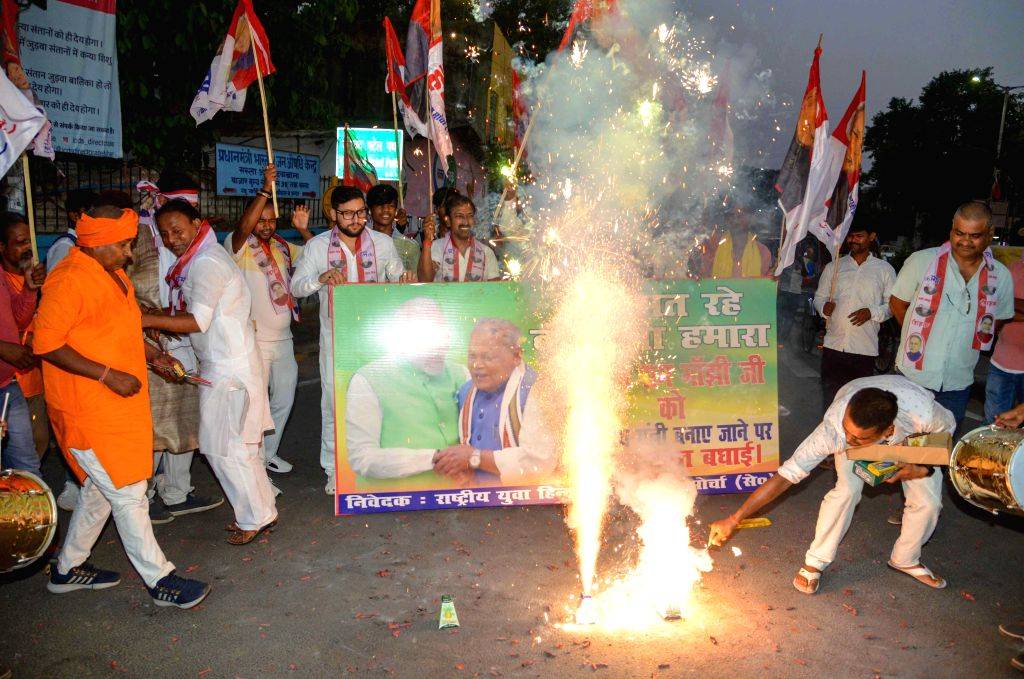 Patna : Hindustani Awam Morcha supporters burst crackers during the ...
