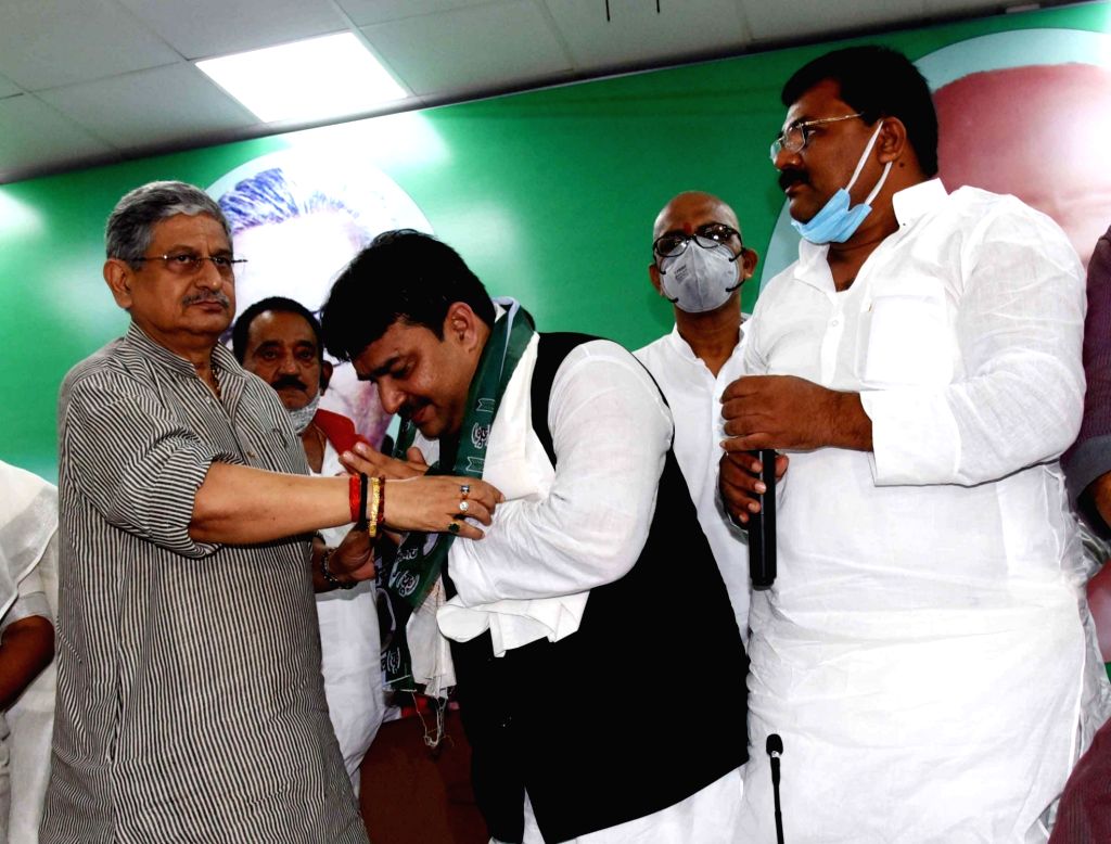 Janta Dal United (JDU) state president Umesh Kushwaha (L) presents ...