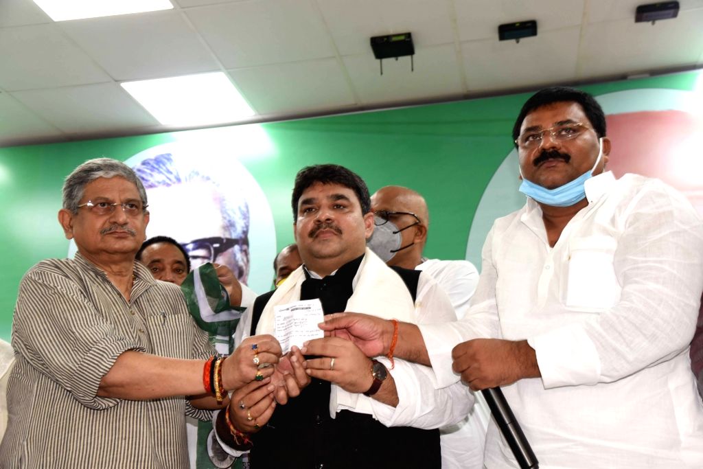 Janta Dal United (JDU) state president Umesh Kushwaha (L) presents ...