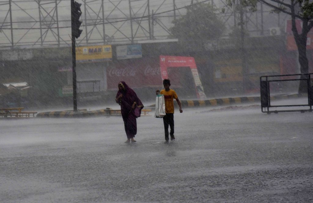 Man riding on bike during heavy rain and cyclone in Patna.
