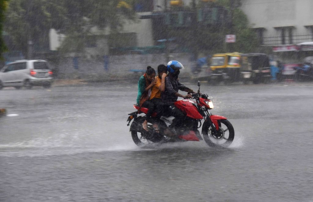Man riding on bike during heavy rain and cyclone in Patna.