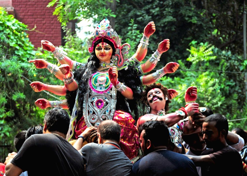 People carry an idol of Goddess Durga for immersion