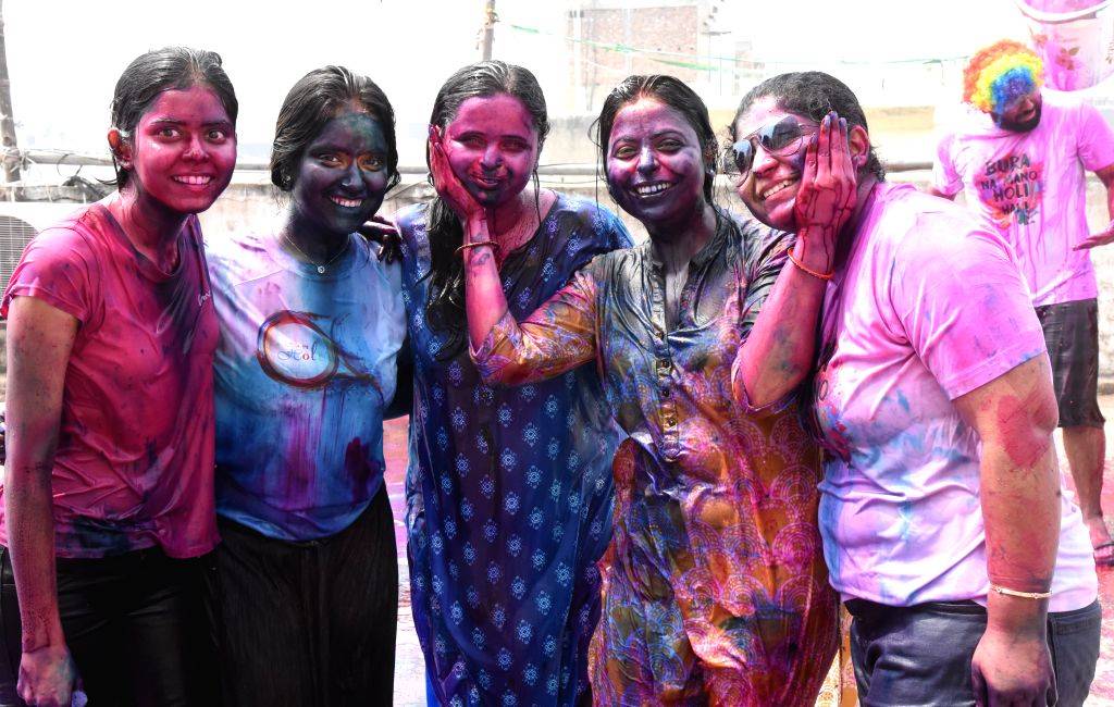 People celebrate with colour during Holi celebrations