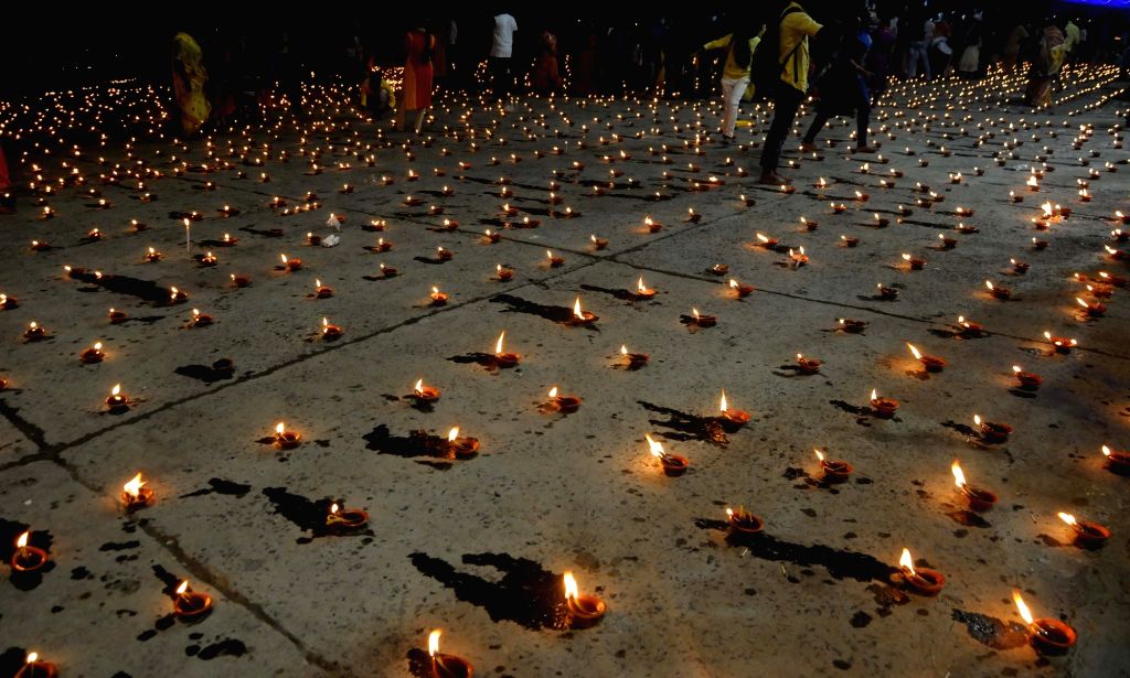 People light up earthen lamps at Nimtala Ghat on Dev Deepawali