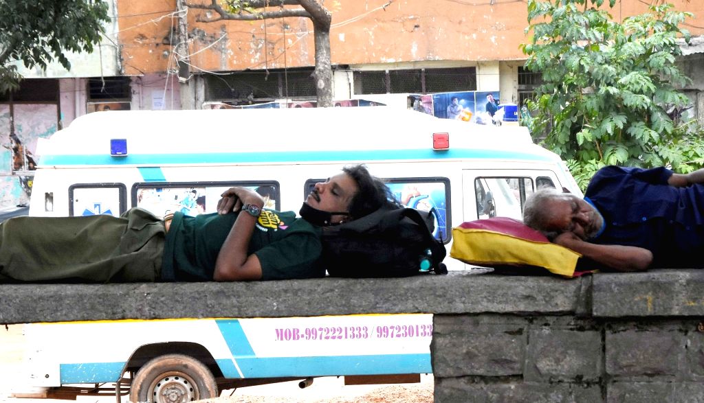 People napping on a wall compound at Bannappa Park during lockdown in ...