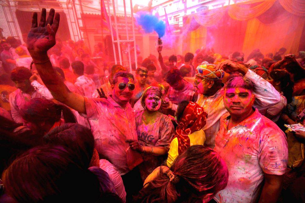 People play with colours during Holi celebrations