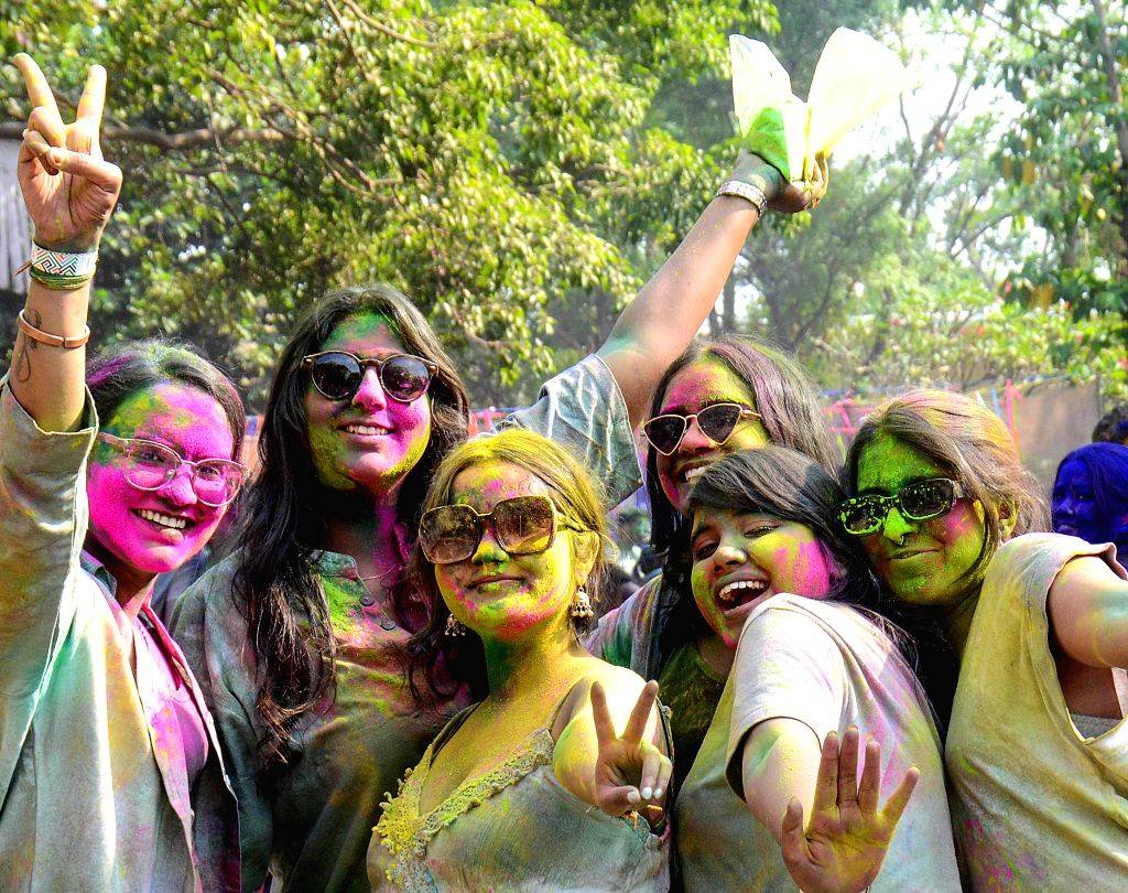 People play with colours during Holi celebrations