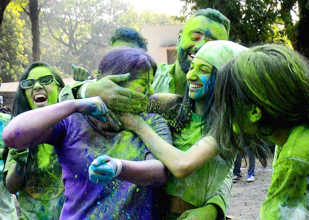 People play with colours during Holi celebrations