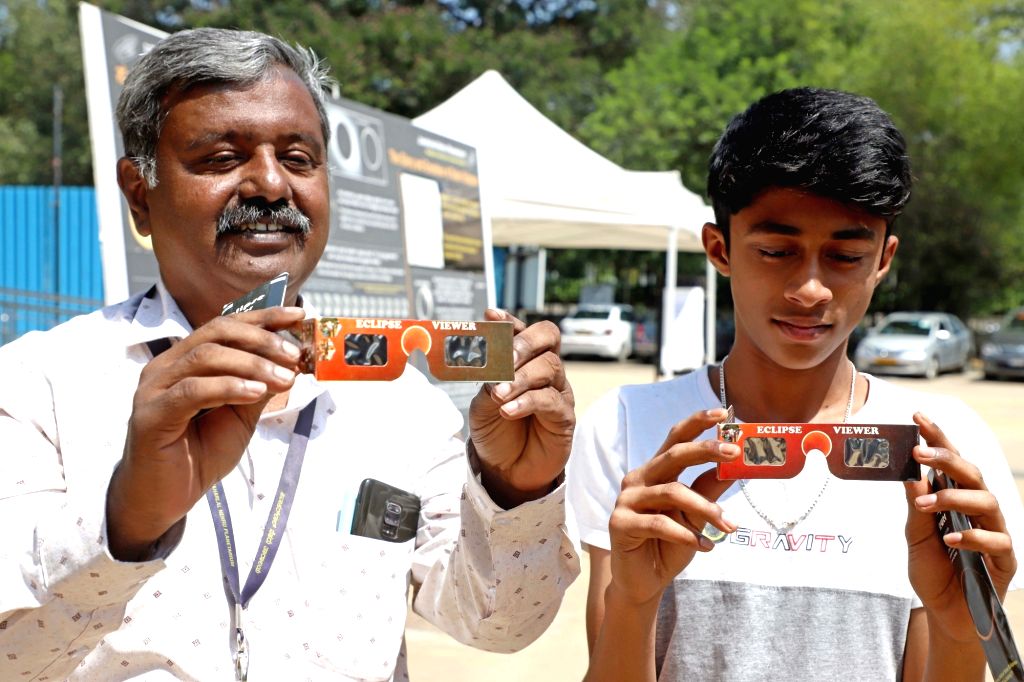 People seen with Eclipse viewer equipment at Nehru Planetarium