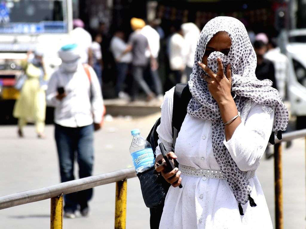 People Shield Themselves from Heat in Amritsar