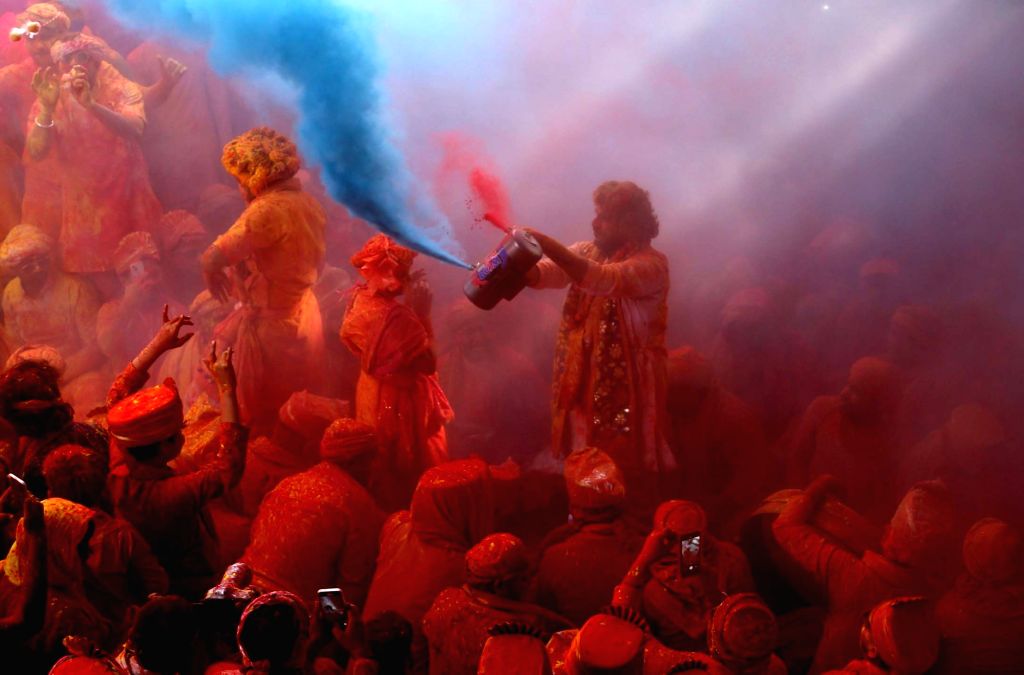 :Barsana :People smeared in colours celebrate the laddu holi.