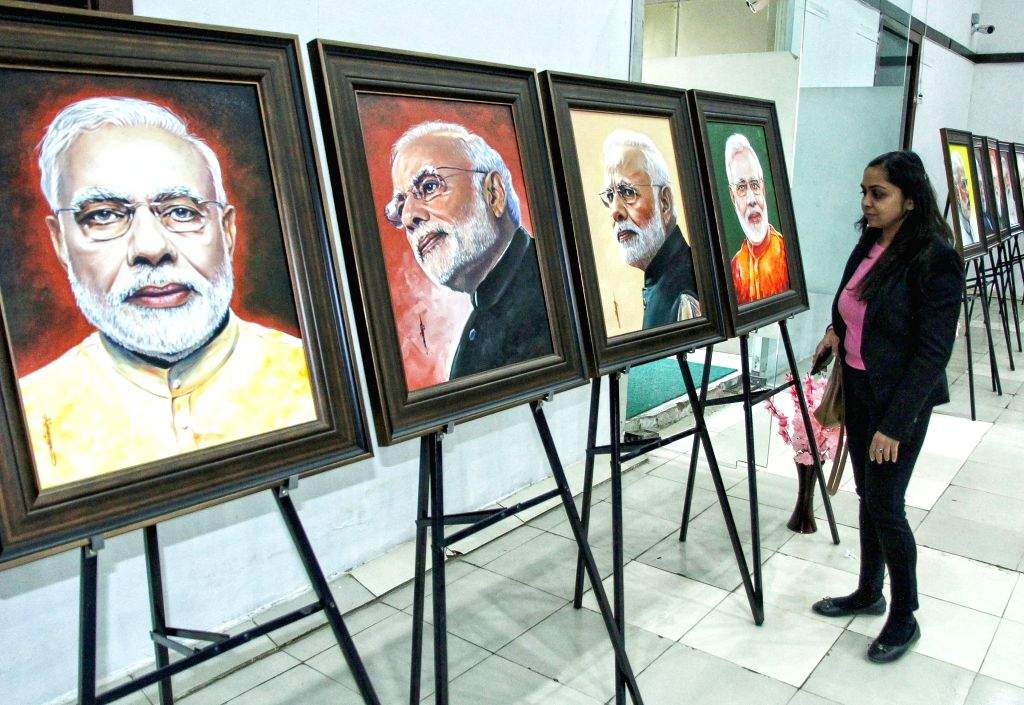 People visit a painting exhibition of Prime Minister Narendra Modi by ...